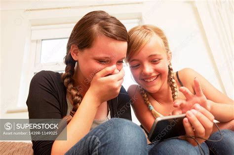 Two Girls Using Smartphone Superstock