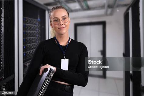 현대적인 서버룸 설정에서 네트워크 장비를 들고 있는 미소 짓는 전문 기술자 It 전문가에 대한 스톡 사진 및 기타 이미지 It 전문가 It 지원 건축물 Istock