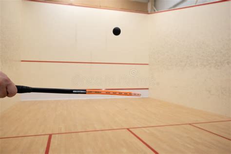 Squash Racket And Ball Inside Court Ball Bouncing Off The Racket Stock
