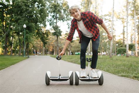 Premium Photo Young Man Riding On Gyro Board In Summer Park