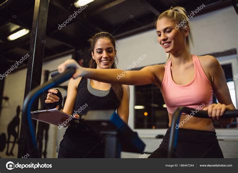 Blonde Girl Finishing Her Workout Bike Gym Talking Personal Coach Stock
