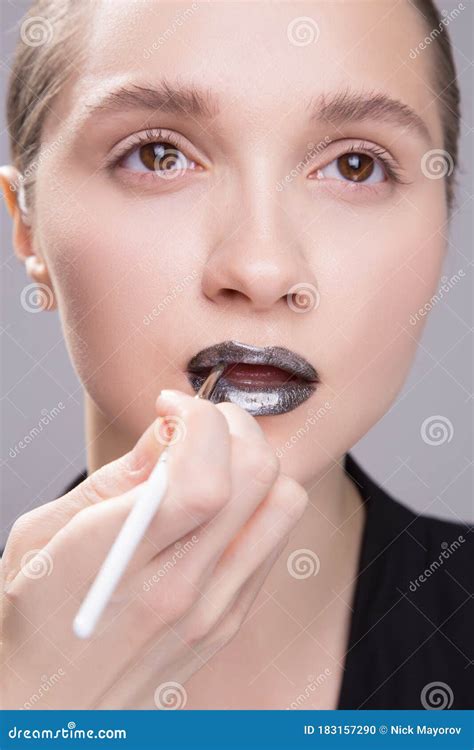 Makeup Artist Applies Black Lipstick Hand Of Make Up Master Painting