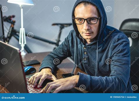 Hacker In The Hood Is Programming Virus Code At The Keyboard For The