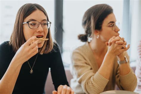Two Women Sharing A Casual Lunch At A Cozy Restaurant Candid