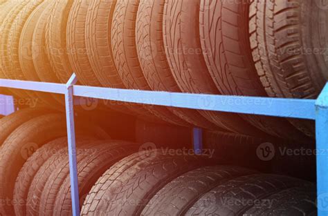 Rack With Variety Of Car Tires In Automobile Store Many Black Tires Tire Stack Background