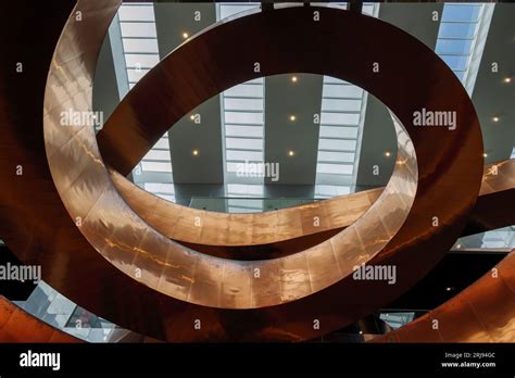 Interior View At The Atrium With Iconic Curvature Copper Staircase At