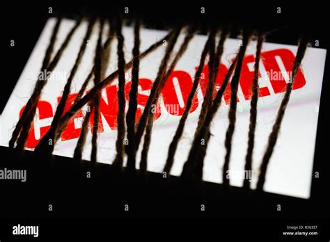 Smartphone Lying On A Table In The Dark Tightly Wrapped And Tied With Coarse Jute Rope Bondage