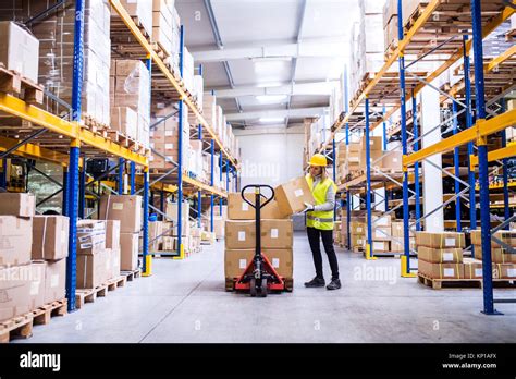 Female Warehouse Worker Loading Or Unloading Boxes Stock Photo Alamy