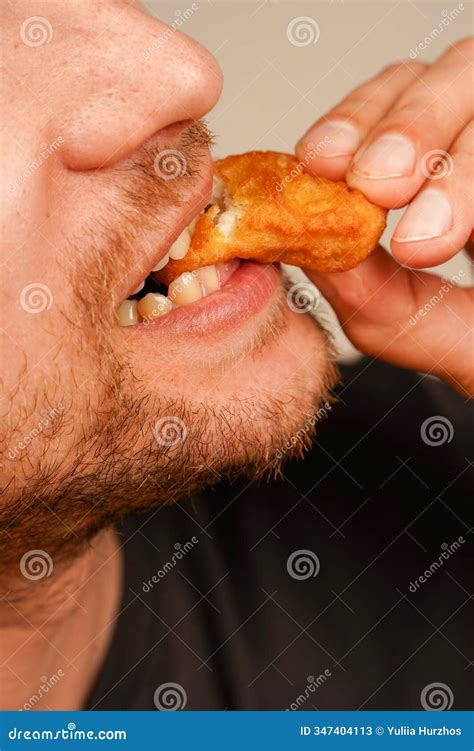 Man Enjoying A Nugget With Rich Details Of Crispy Texture And Golden