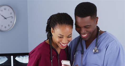African American Medical Doctors Taking Wacky Selfies Together Stock