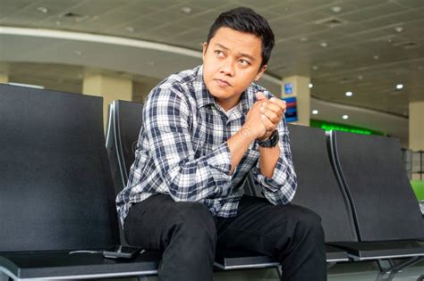 Asian Manwaiting For Plane In Airport Waiting Area Male Tourist