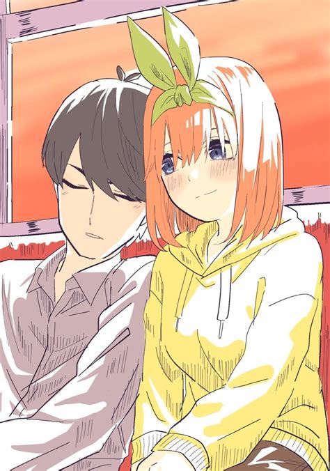 Two People Sitting Next To Each Other On A Couch