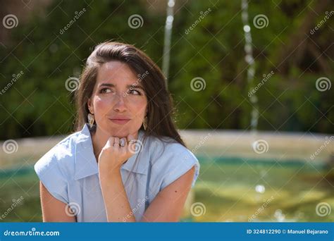 Portrait Of A Young Woman Natural With Brown Hair And Light Blue