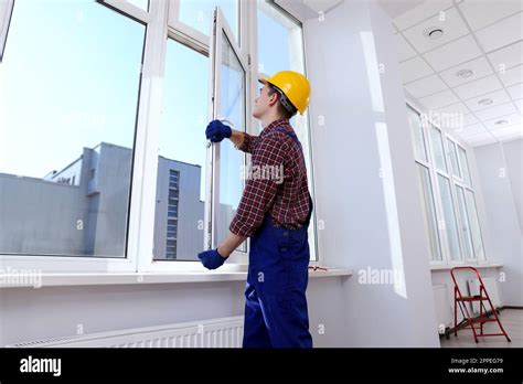 Worker In Uniform Installing Plastic Window Indoors Stock Photo Alamy