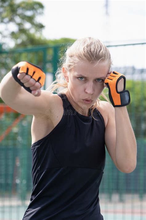 Young Female Boxer Training In The Stadium Standing In Position Stock