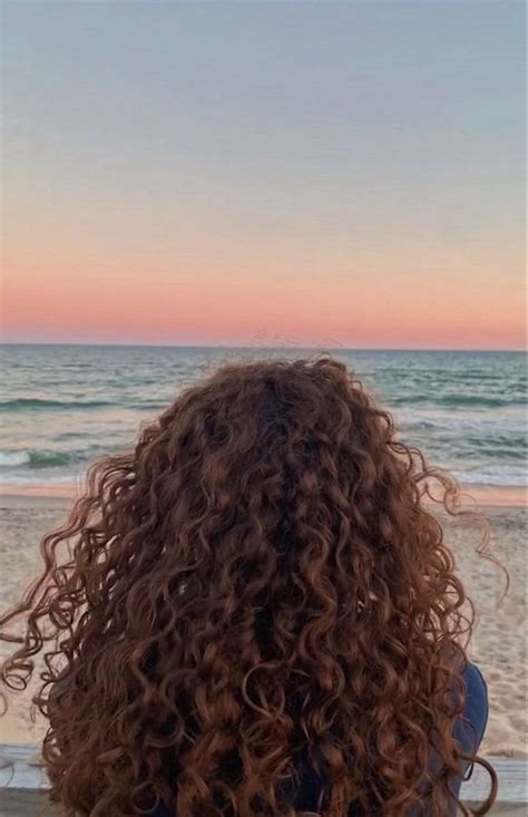 Curly Hair Girl Sitting On The Beach With Brownish Red Hair Wavy Hair
