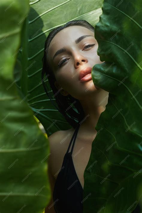 Premium Photo Beautiful Summer Girl Behind Palm Leaves Young Sexy
