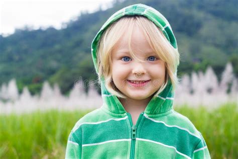 Niño Lindo Feliz En Sudadera Con Capucha Delante De Un Campo Foto De