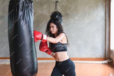 Premium Photo Sexy Asia Girl Punching Boxing Bag