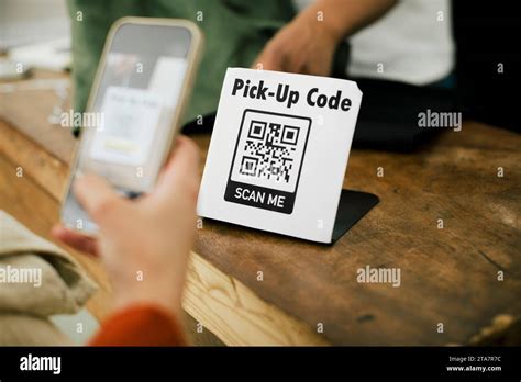 Hand Woman Woman Scanning QR Code Through Smart Phone While Doing Online Payment At Store Stock