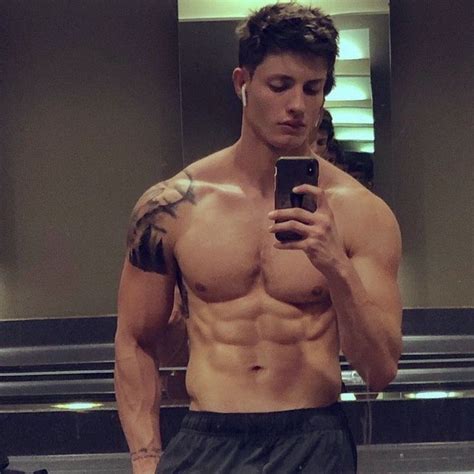 A Shirtless Man Taking A Selfie In Front Of A Mirror With His Cell Phone