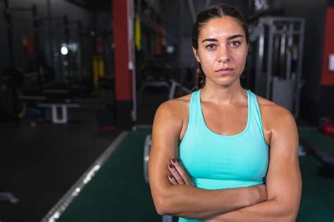 Premium Photo Female Athletic Standing With Arms Crossed In Fitness