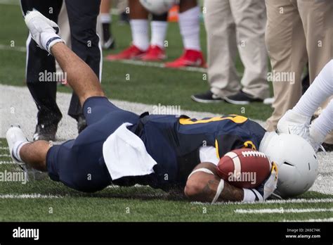 a football player on the ground during a college football game stock