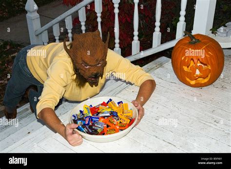 Werewolf Taking Candy With Carved Pumpkin On Halloween Front Porch