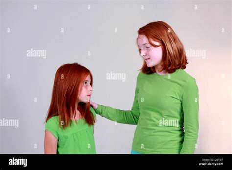 Pretty Red Haired Older Sister Comforting Little Redhead Sister Stock