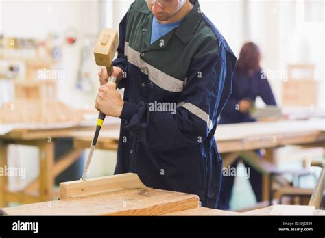 Craftsman Using Mallet And Chisel Stock Photo Alamy