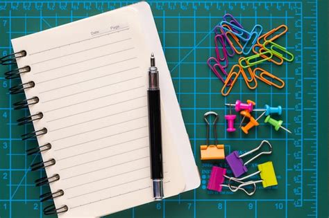 Premium Photo Blank Notebook Pen And Paper Clips On Green Cutting Pad