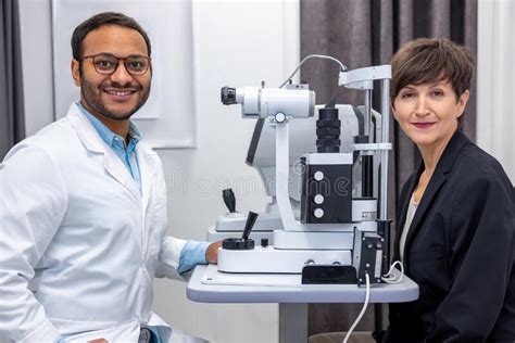 Male Doctor Working On Optometric Equipment At Clinic Stock Image
