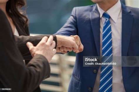 가까이 실업가 주먹을 만들기의 배경에서 젊은 여자와 건물에 밤 비즈니스 사람들이 착용 정장 좋은 거래 후 주먹 펌프에 함께 할