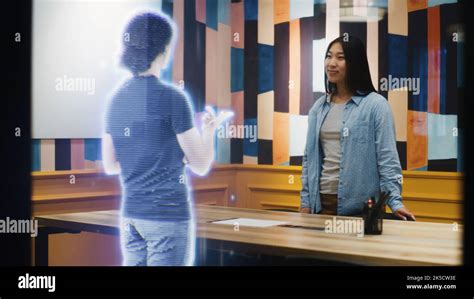 Asian Woman Talks On The Call With Her Friend Using Augmented Reality Software Hologram Of Her