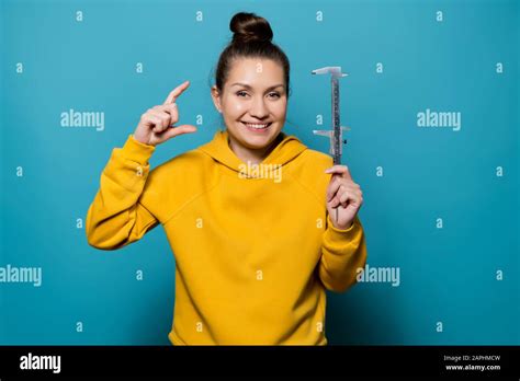 The Girl Depicts The Magnitude With Her Fingers And Shows The Caliper