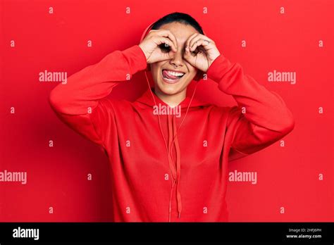 Beautiful Hispanic Woman With Short Hair Listening To Music Using