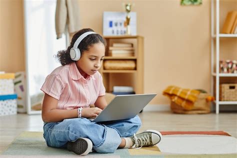 Premium Photo Cute Schoolgirl N Headphones Typing On Laptop Keyboard