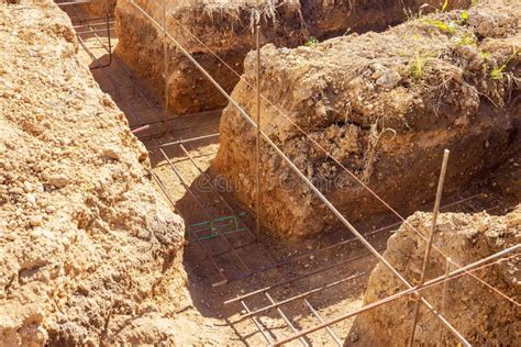 Constructing A Concrete Foundation From Digging An Earthen Trench Stock