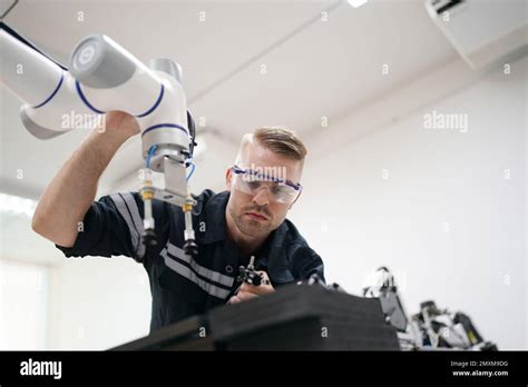 Engineers Maintenance Robot Arm At Lab In A High Tech Research