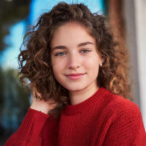 Premium Photo A Closeup Portrait Of A Young Woman With Curly Brown
