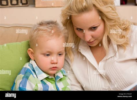 The First Book Portrait Of Attractive Mom And Son Reading A Book