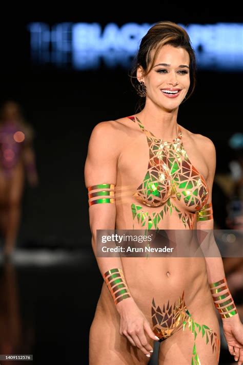 A Model Walks The Runway Wearing Black Tape Project At Miami Swim
