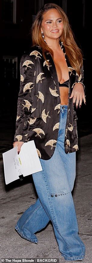 Chrissy Teigen Bares Cleavage And Taut Midriff As She Heads Off To Play