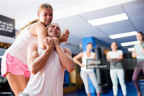 Girl Practicing Guillotine Choke On Opponent In Sparring With Man Stock Photo - Download Image ...