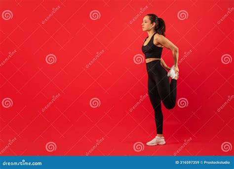 Fitness Lady Performs Quad Stretch Against Red Background Stock Image Image Of Flexibility