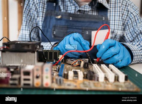 Closeup Hands Of Female Technician Measuring Electrical Voltage Of