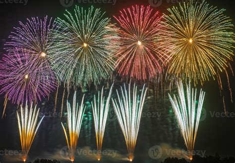 Multiple Fireworks Of Different Colors Going Off Simultaneously Lighting Up The Night With