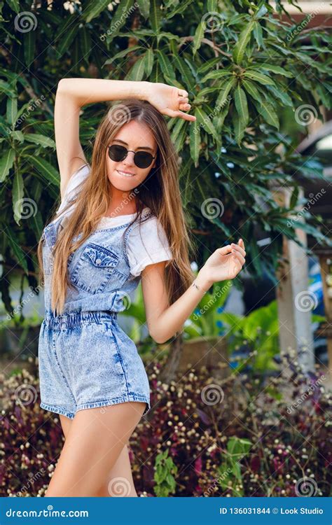 Cute Slim Tanned Girl Standing Near Tree She Wears White T Shirt