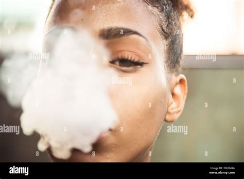 Portrait Of A Black Girl With Smoke Coming Out Of Her Mouth That Covers