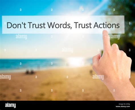 Don't Trust Words, Trust Actions - Hand pressing a button on blurred background concept ...